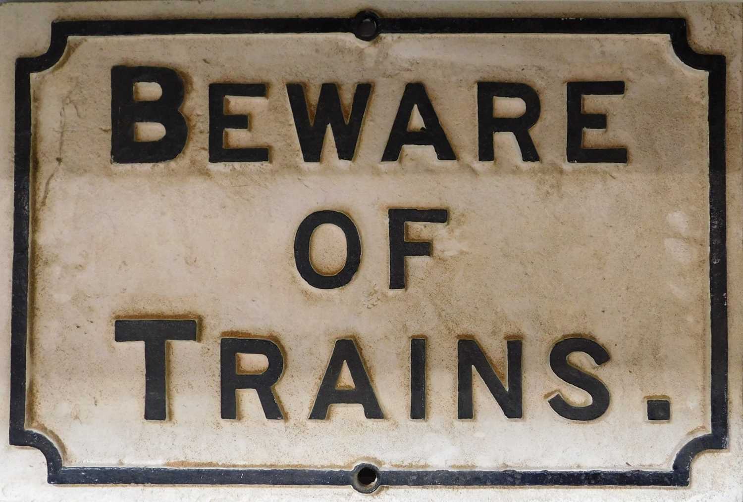 Lot 74 - A cast metal Beware of Trains sign.