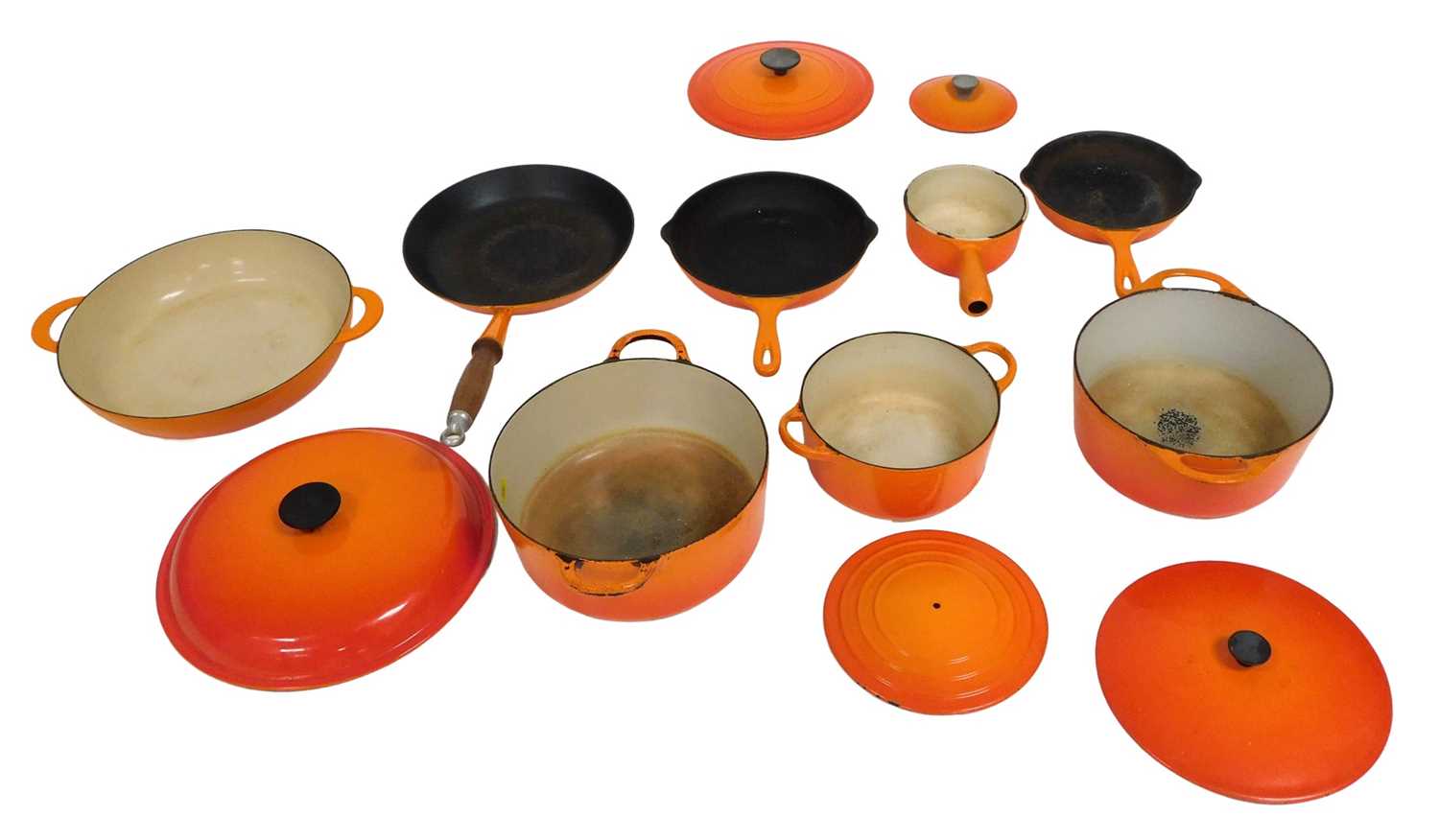 Lot 98 - A group of Le Creuset orange enamel cookware,
